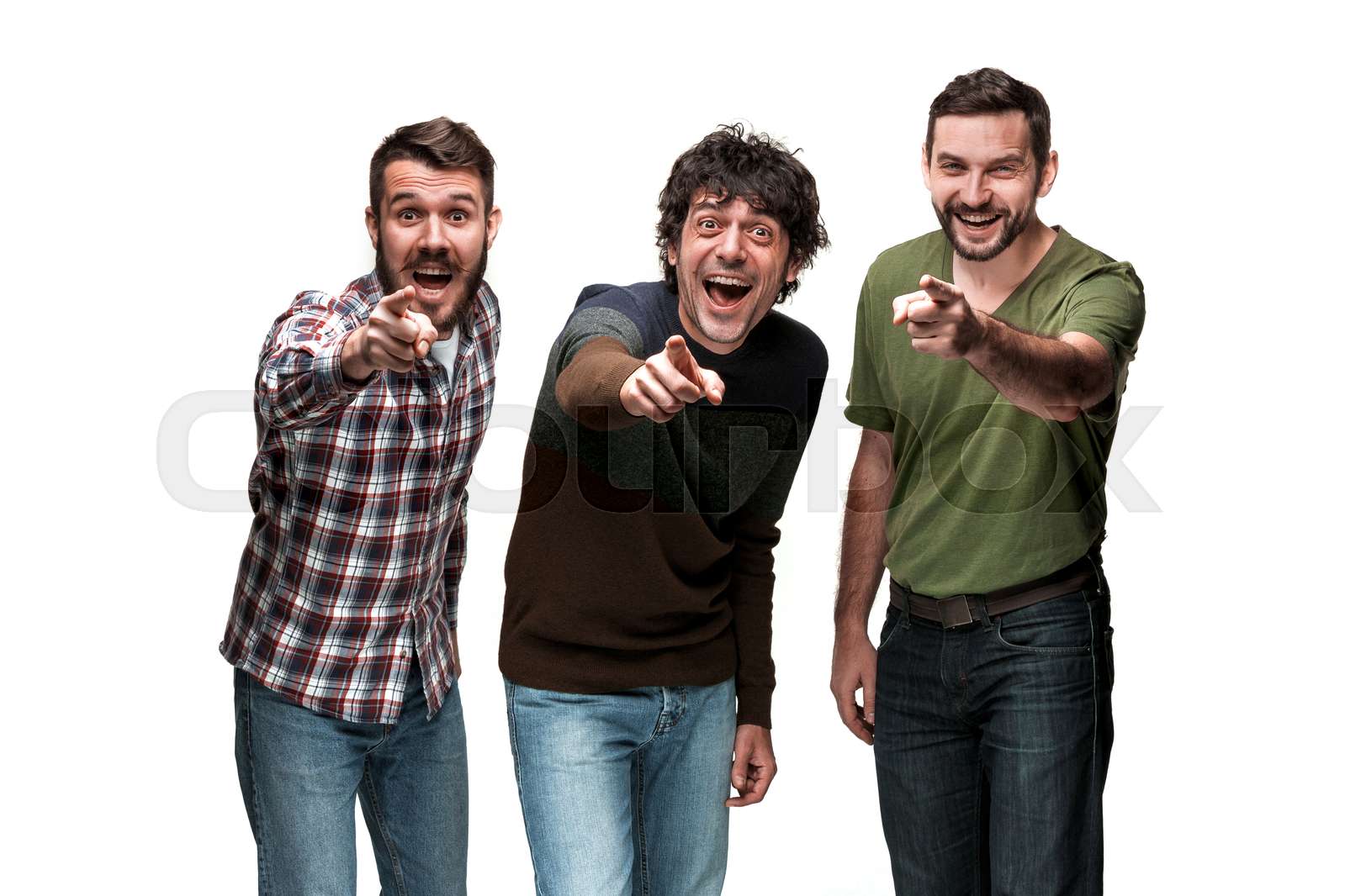 The three men are smiling, looking and pointing at camera | Stock image ...