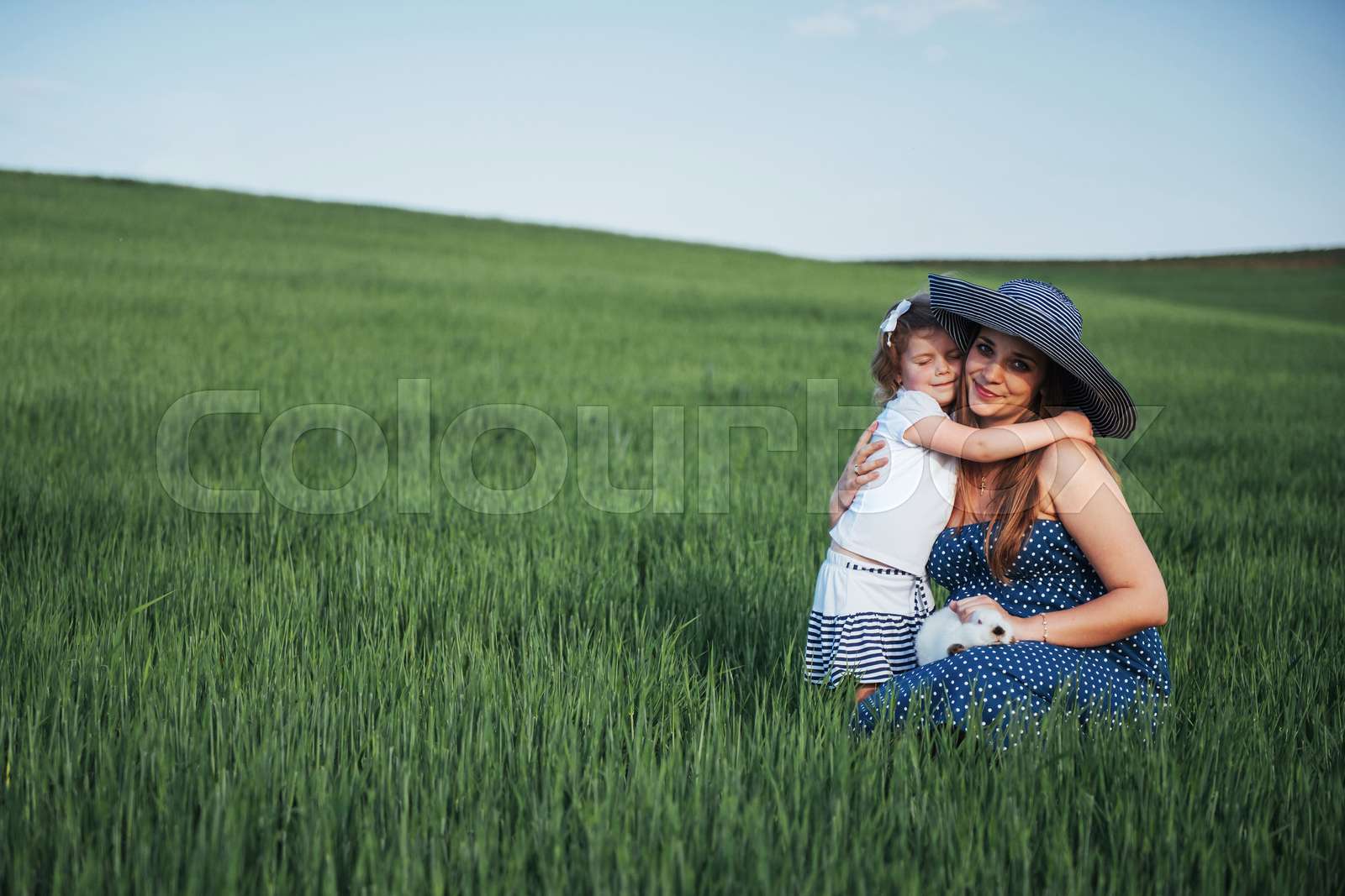 Happy family with two people hugging in the streets. The mother ...