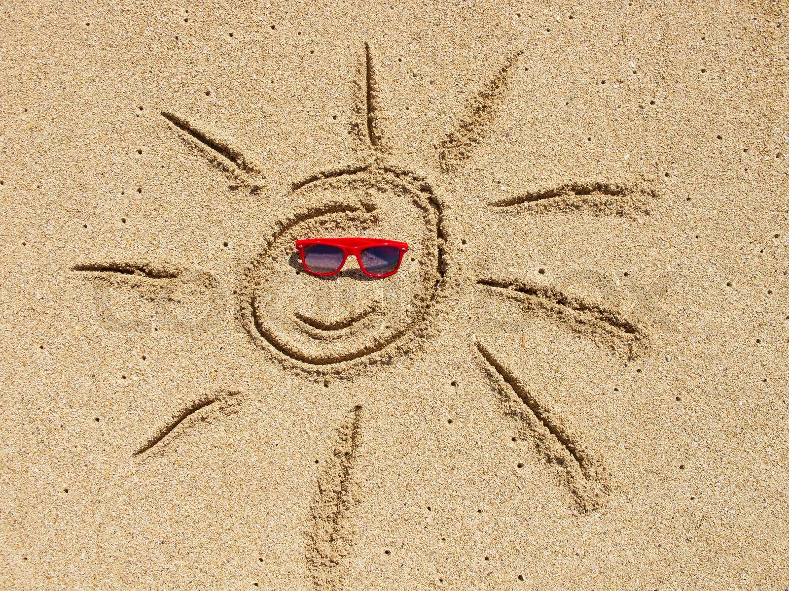 simple sun drawing in the wet sand on the beach | Stock image | Colourbox