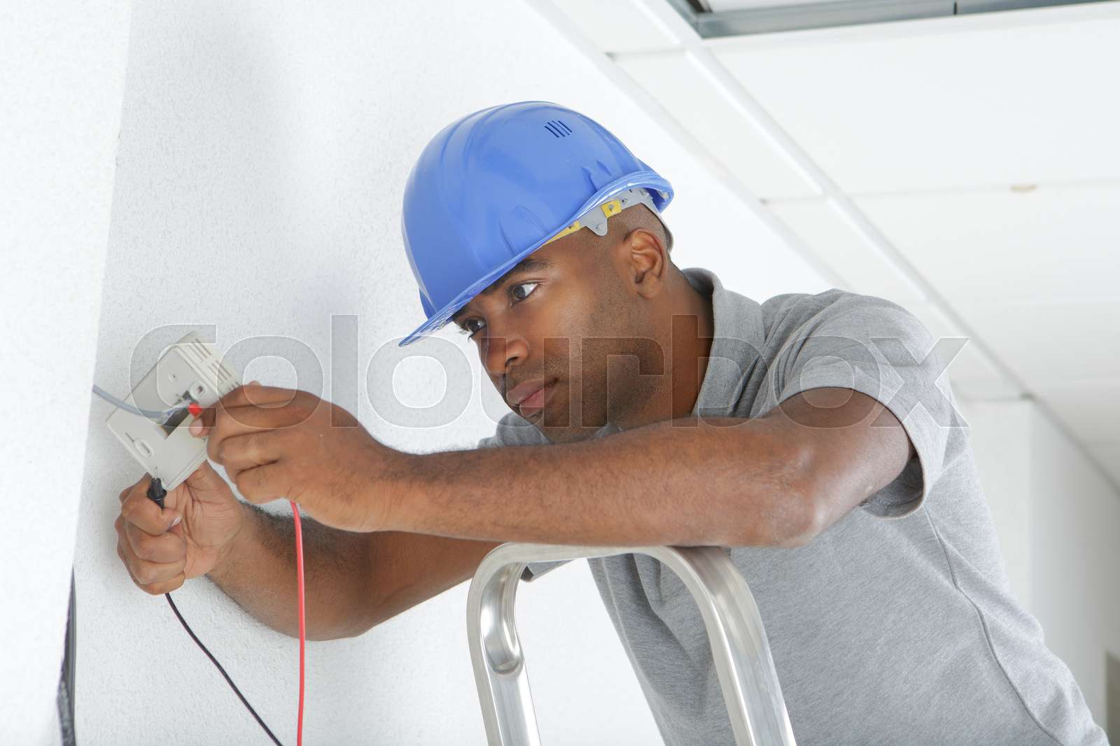 man installing wiring | Stock image | Colourbox