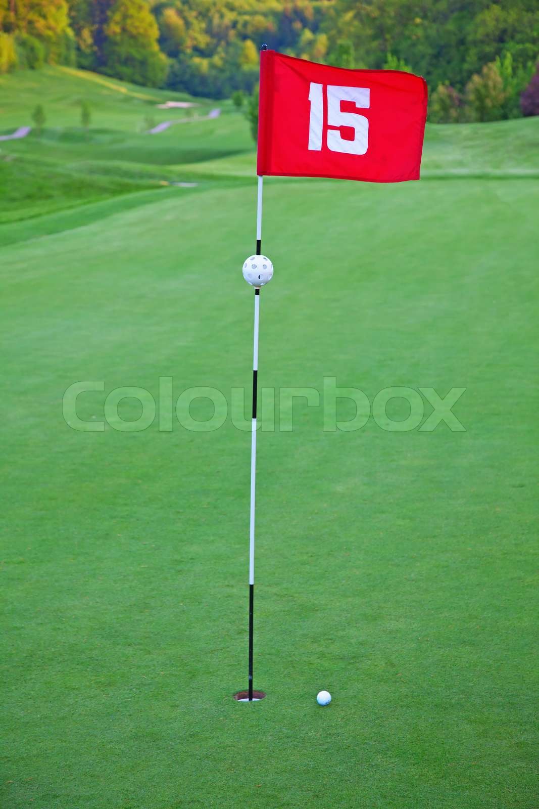 Golf flag on the green grass | Stock image | Colourbox