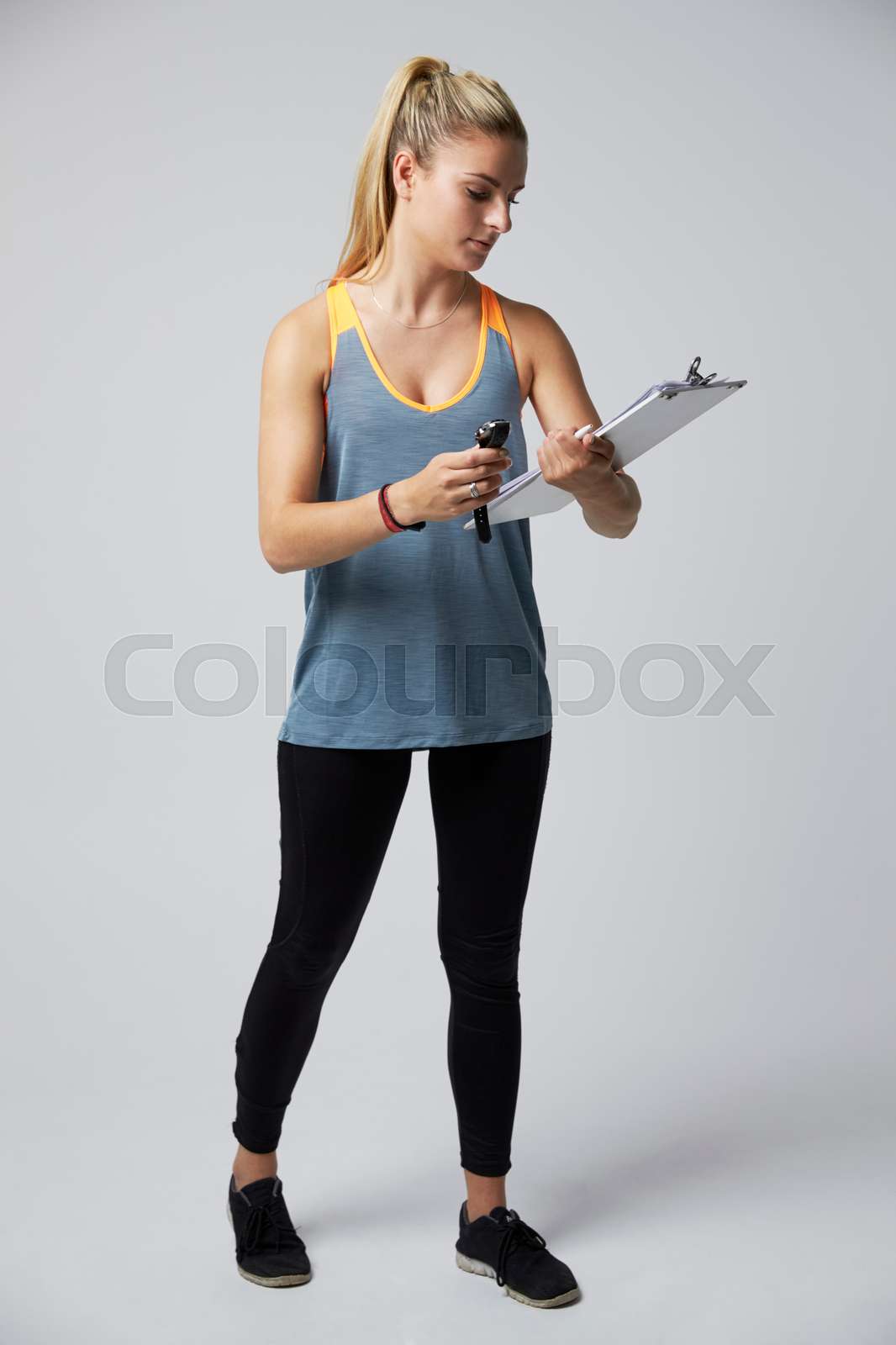 Studio Portrait Of Female Sports Coach With Clipboard | Stock image ...