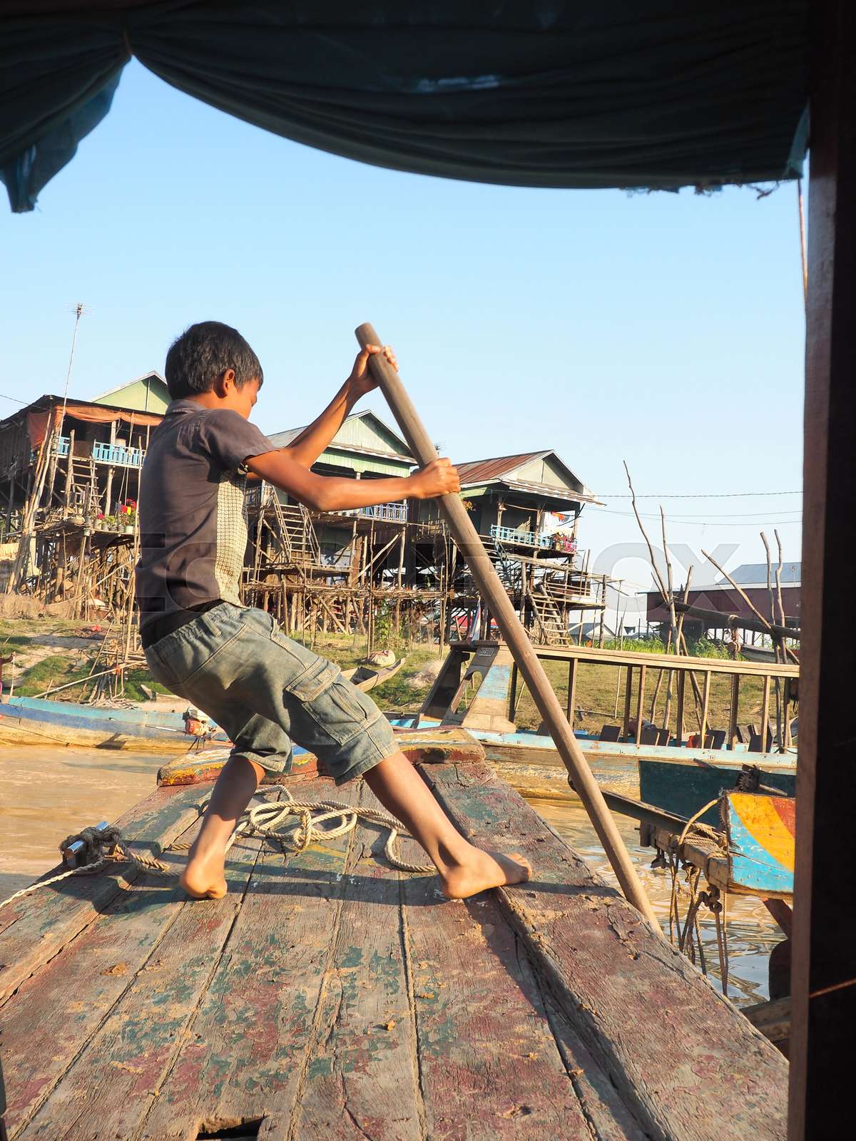 poor kid on the boat | Stock image | Colourbox