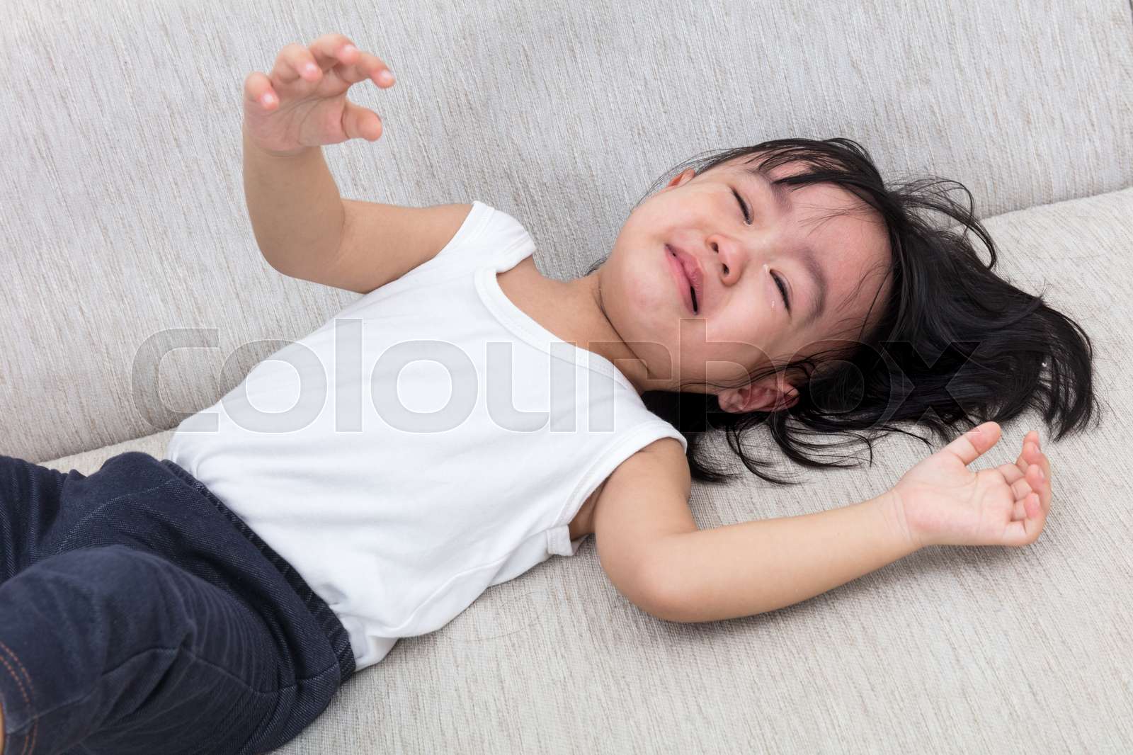 Asian Chinese little girl crying on the sofa | Stock image | Colourbox