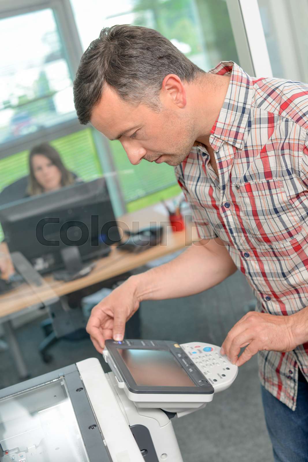 Using the office printer | Stock image | Colourbox