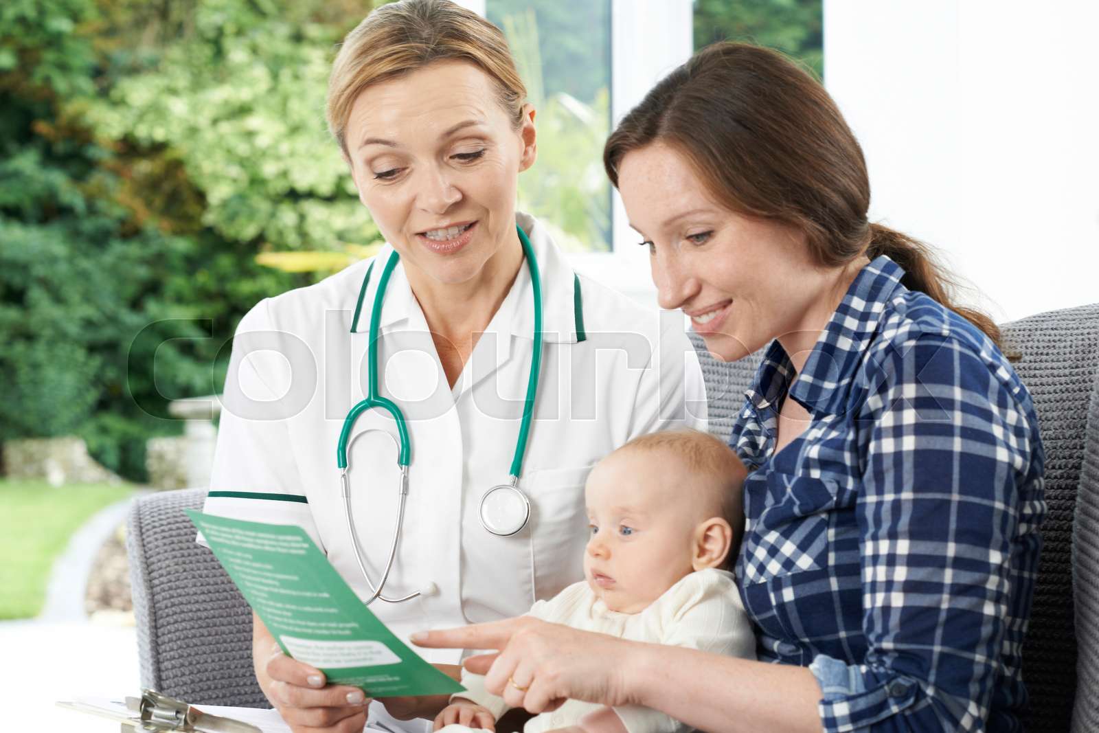 Health Visitor Giving Mother Leaflet With Advice On Baby | Stock image ...