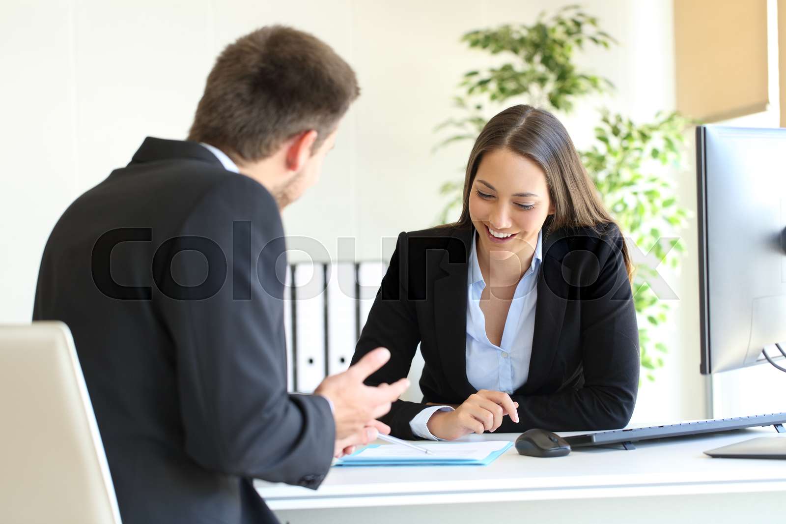 Salesman selling to a client at office | Stock image | Colourbox