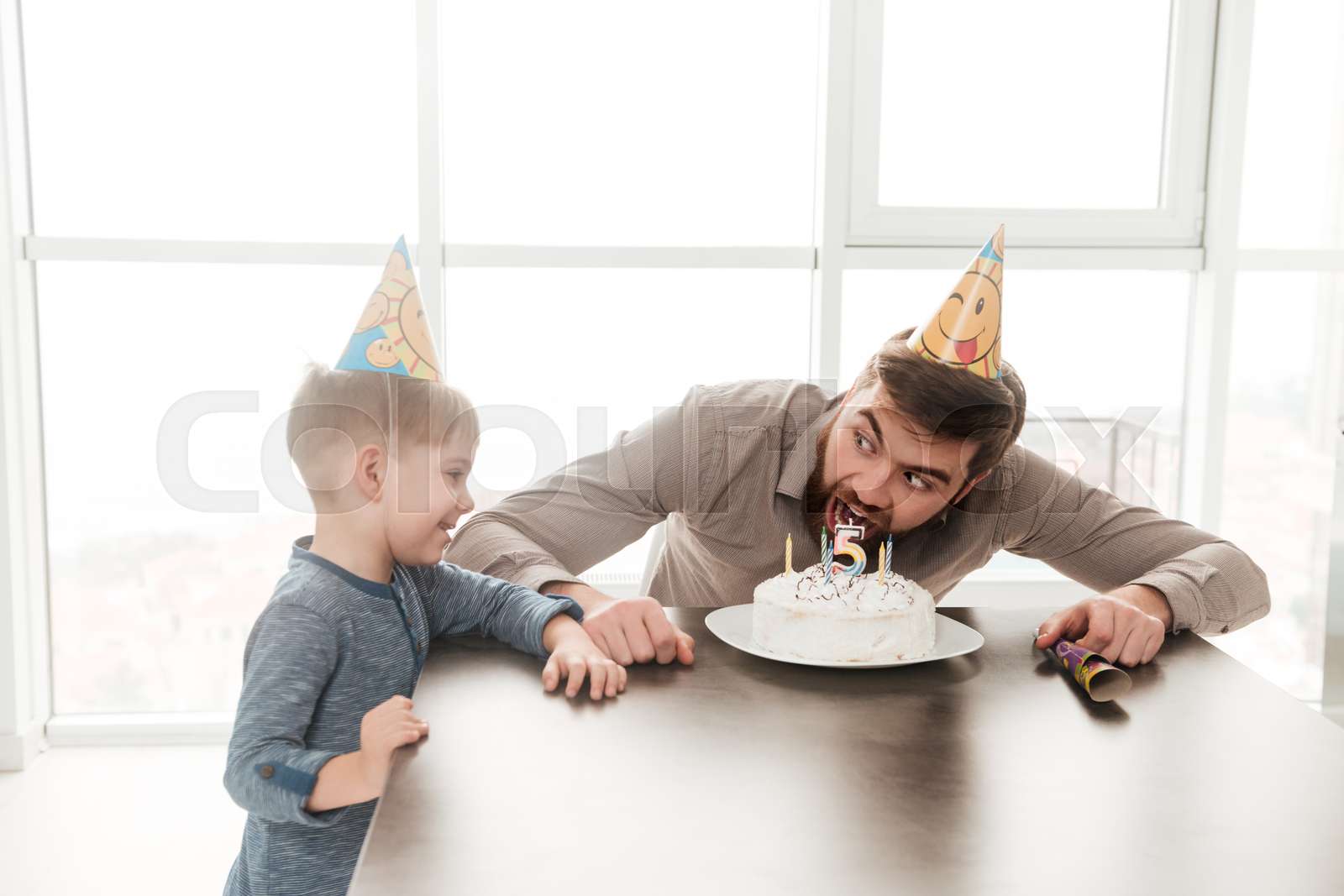 Funny bearded father try to eating birtday cake of son. | Stock image ...