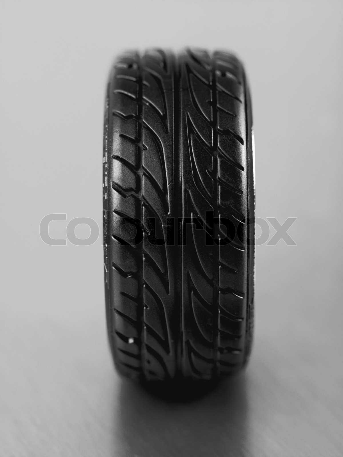 Rubber tyres with sports rims on a silver background | Stock image ...