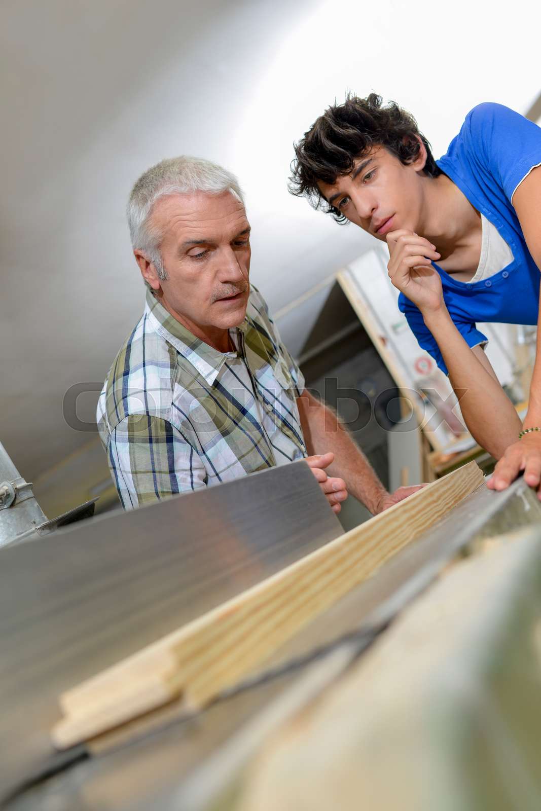 Craftsman giving instructions to his apprentice | Stock image | Colourbox