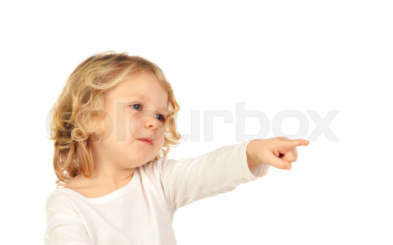 Cute kid pointing with his finger | Stock image | Colourbox