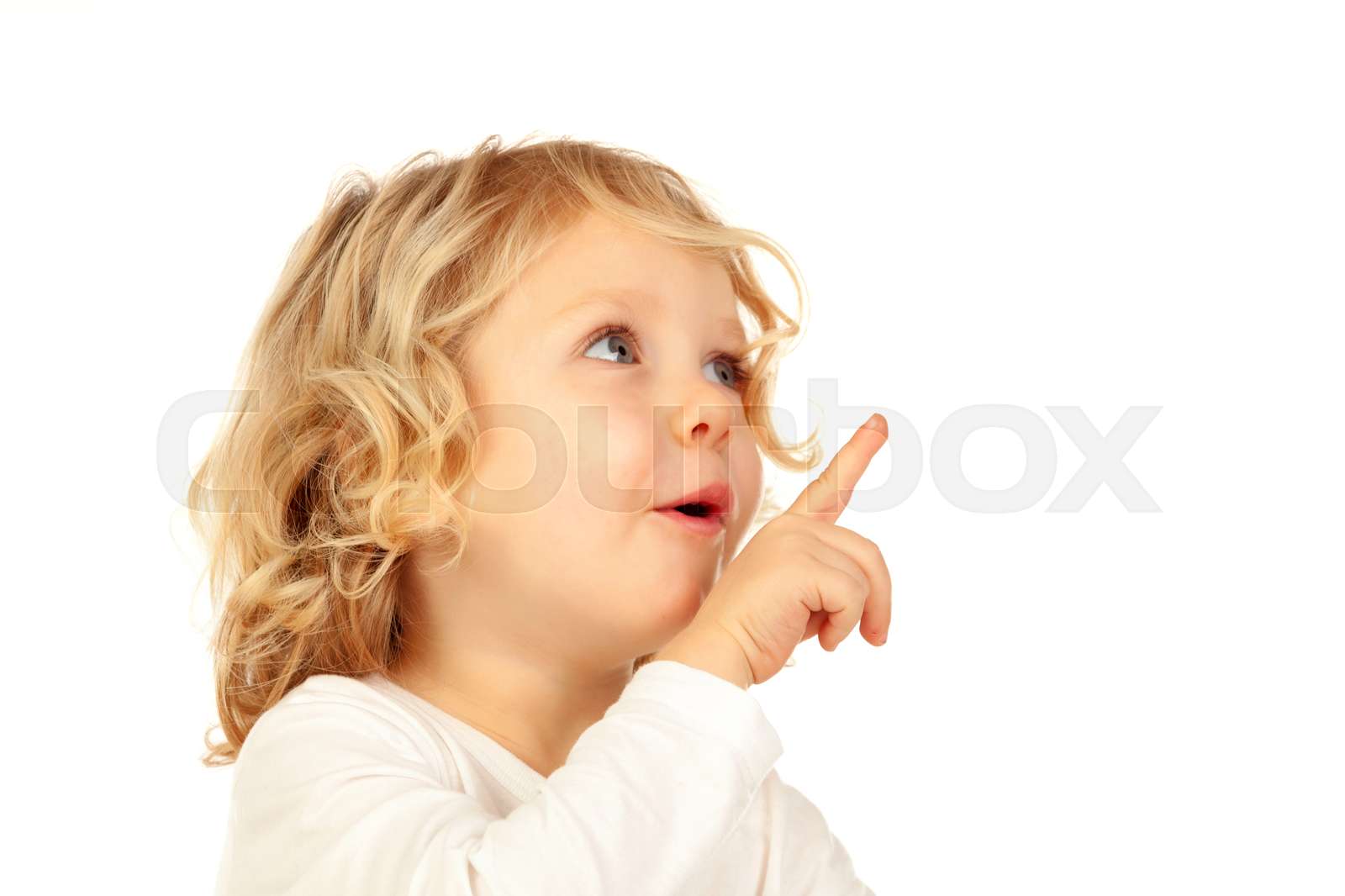 Cute kid pointing with his finger | Stock image | Colourbox