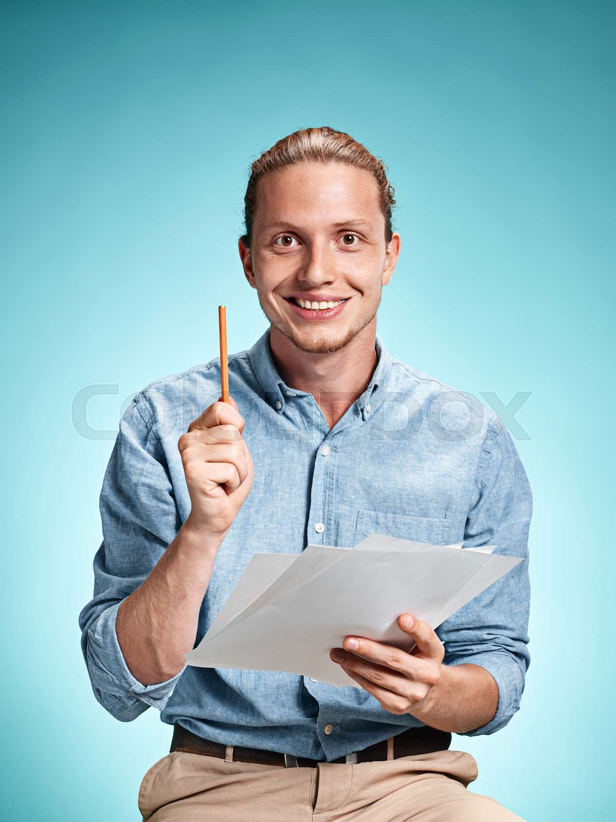 Smart smiling student with great idea holding sheets of paper | Stock ...