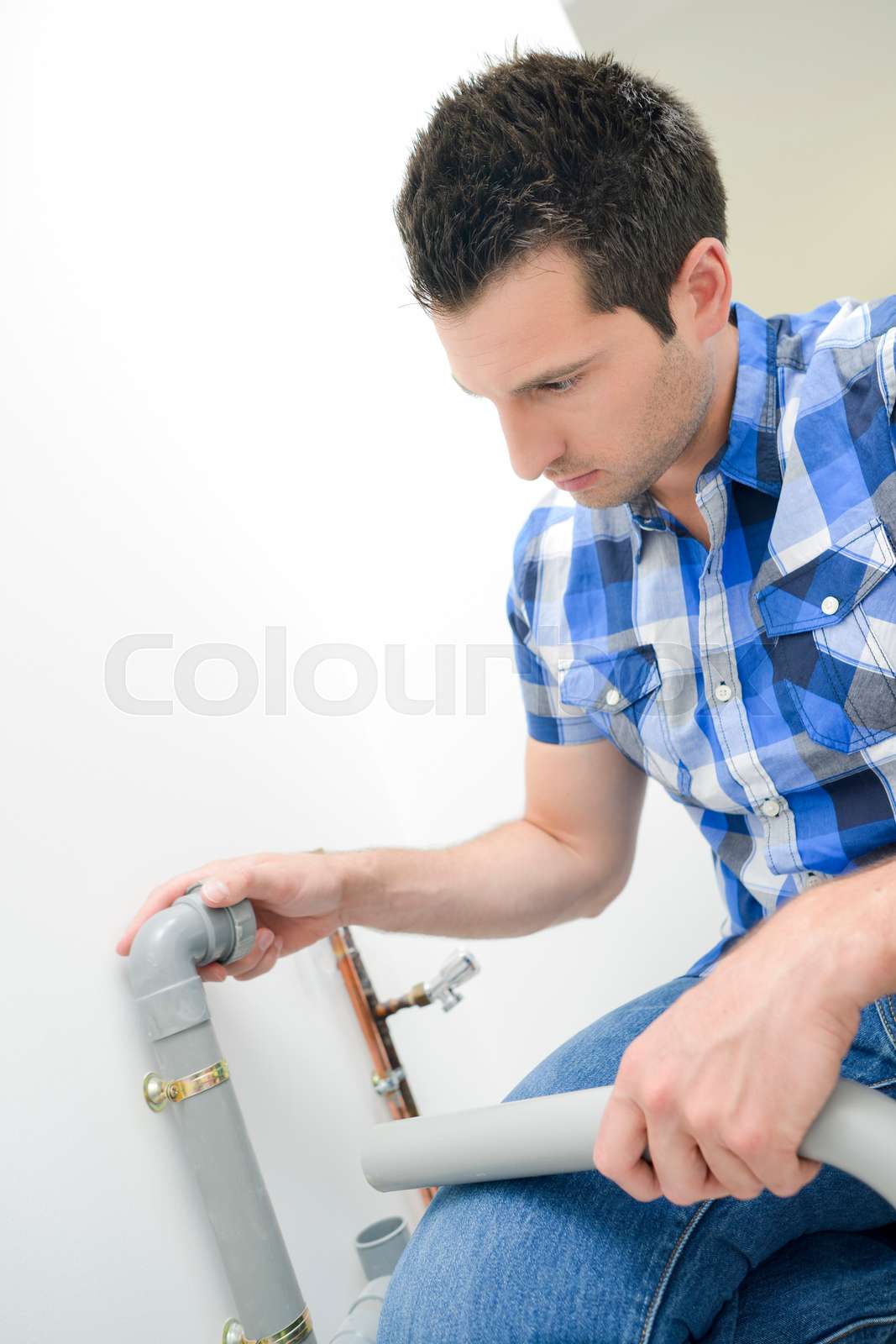 Plumber hard at work | Stock image | Colourbox
