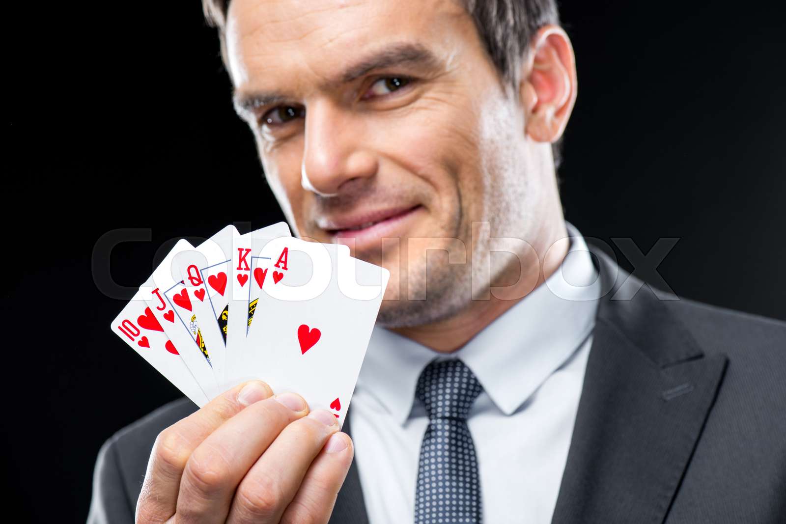 Man holding playing cards | Stock image | Colourbox