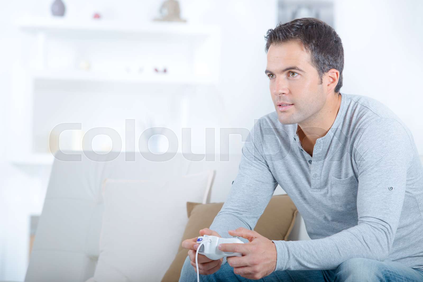 Man playing video games alone | Stock image | Colourbox