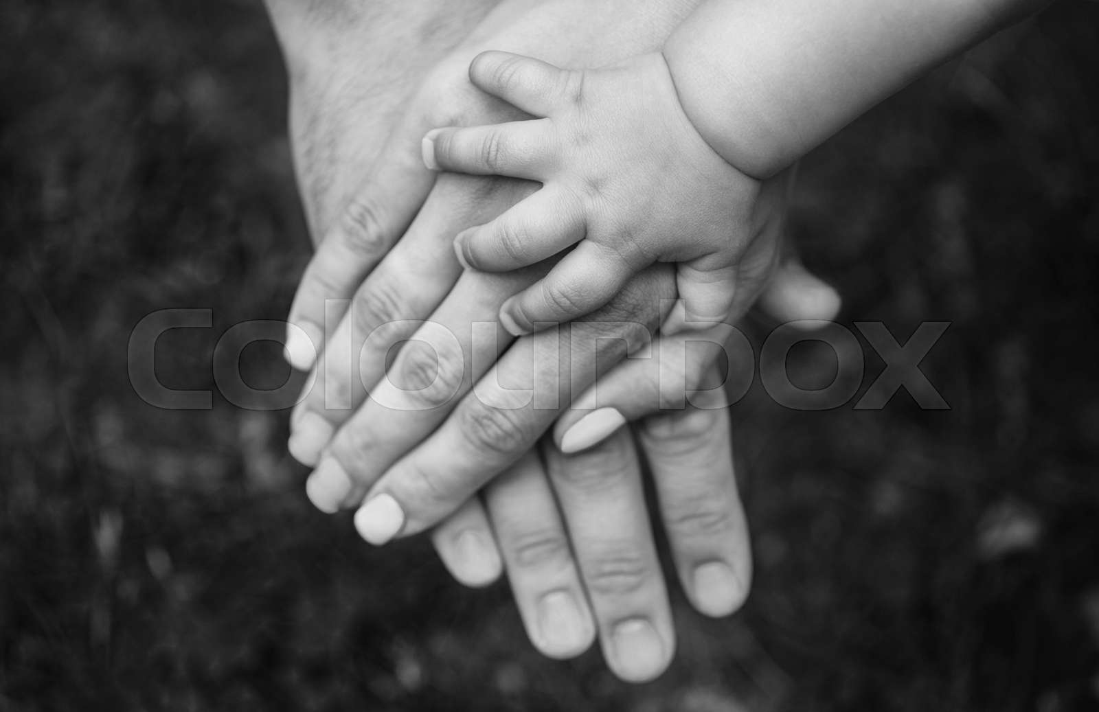 Three hands of the same family - father, mother and baby stay together ...