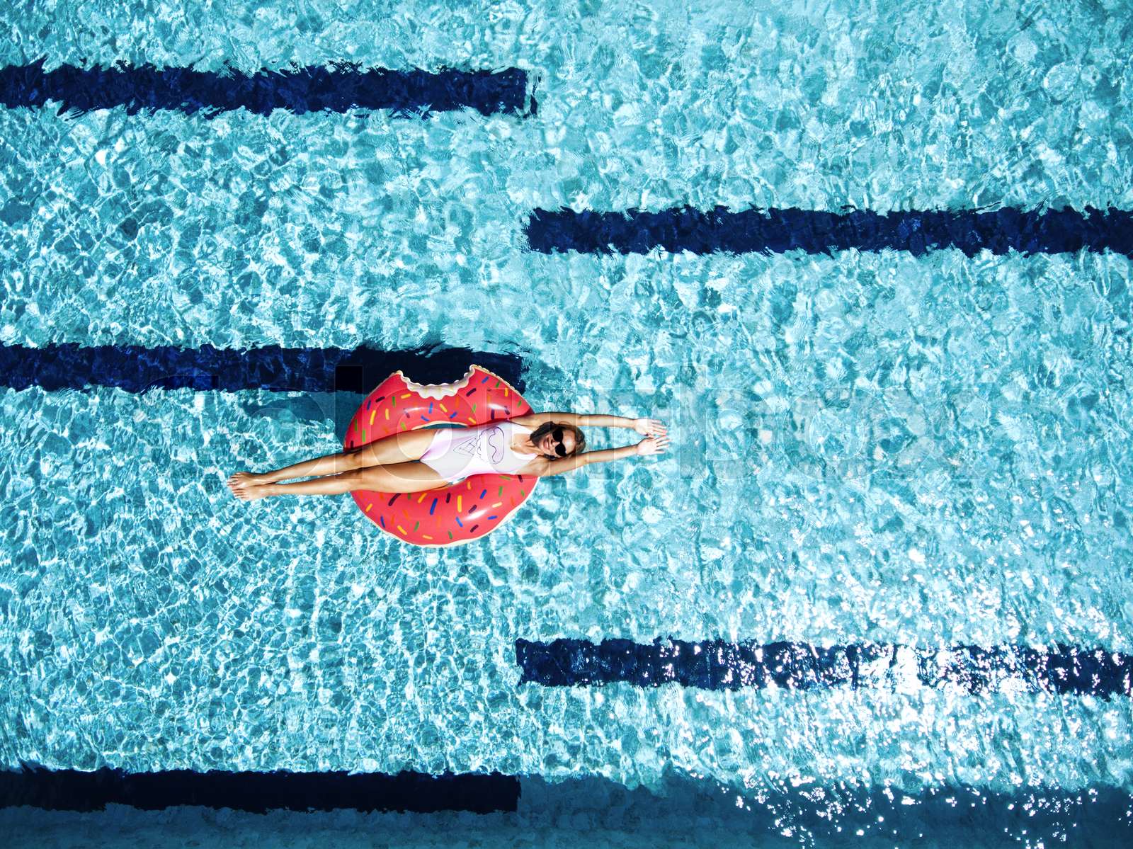 Woman relaxing with lilo in pool | Stock image | Colourbox