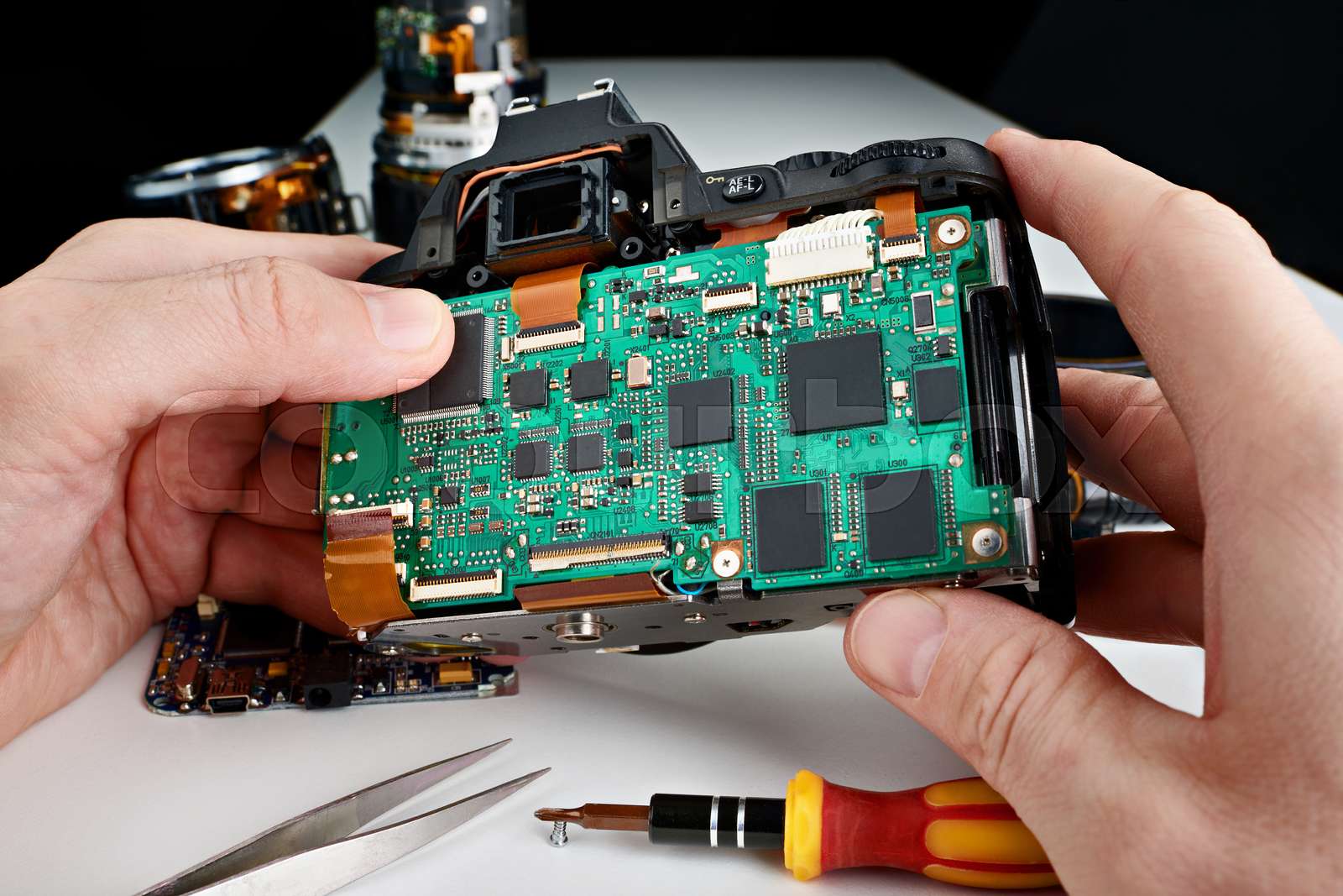 Repair broken photo DSLR camera in service | Stock image | Colourbox