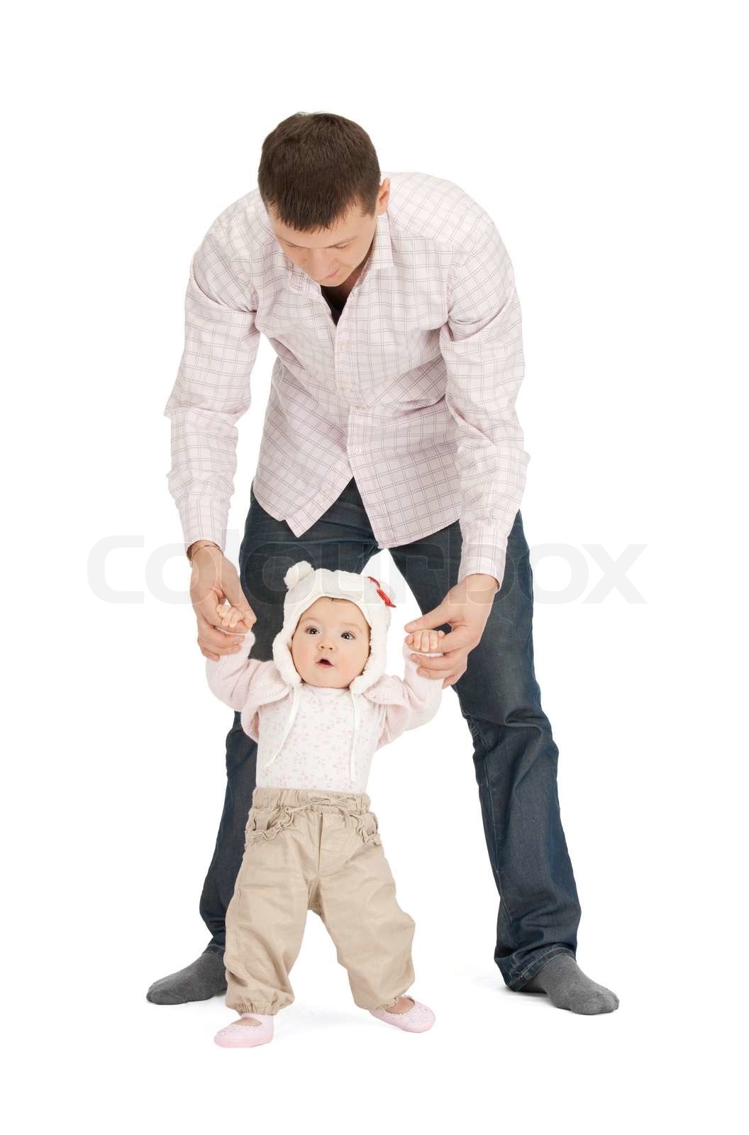 picture of baby making first steps with father help | Stock image ...