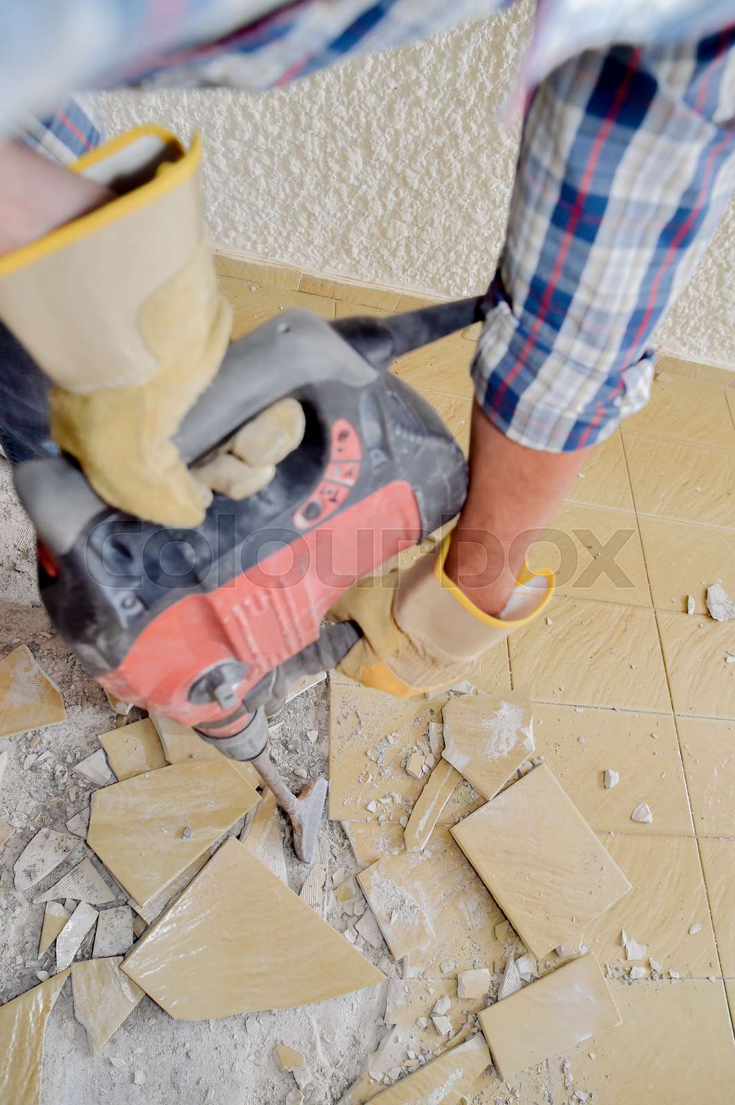 Using pneumatic device to break old tiles | Stock image | Colourbox
