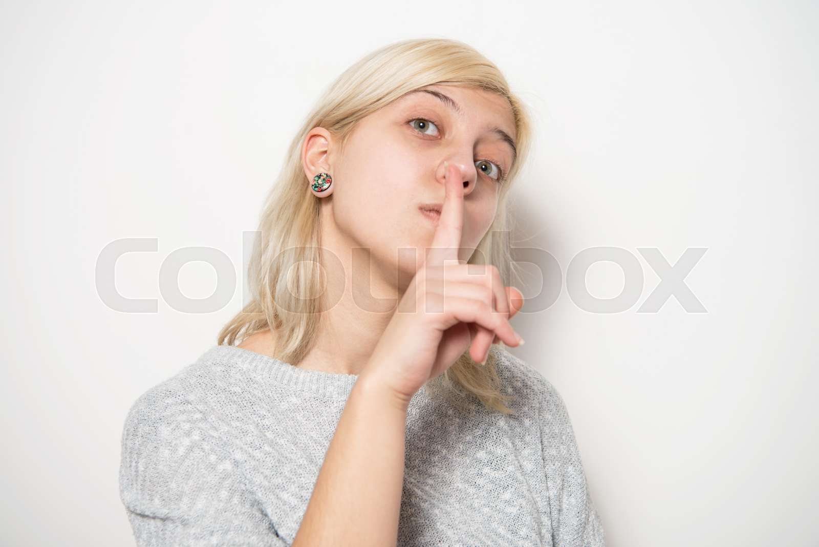 woman put finger on her lips | Stock image | Colourbox