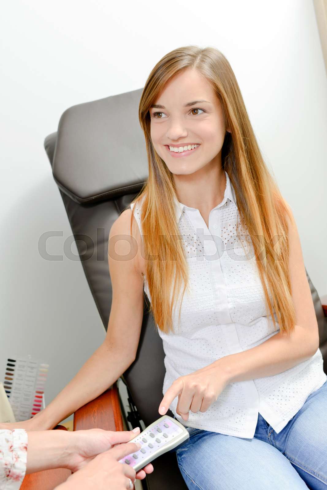 Cute girl getting her nails done | Stock image | Colourbox