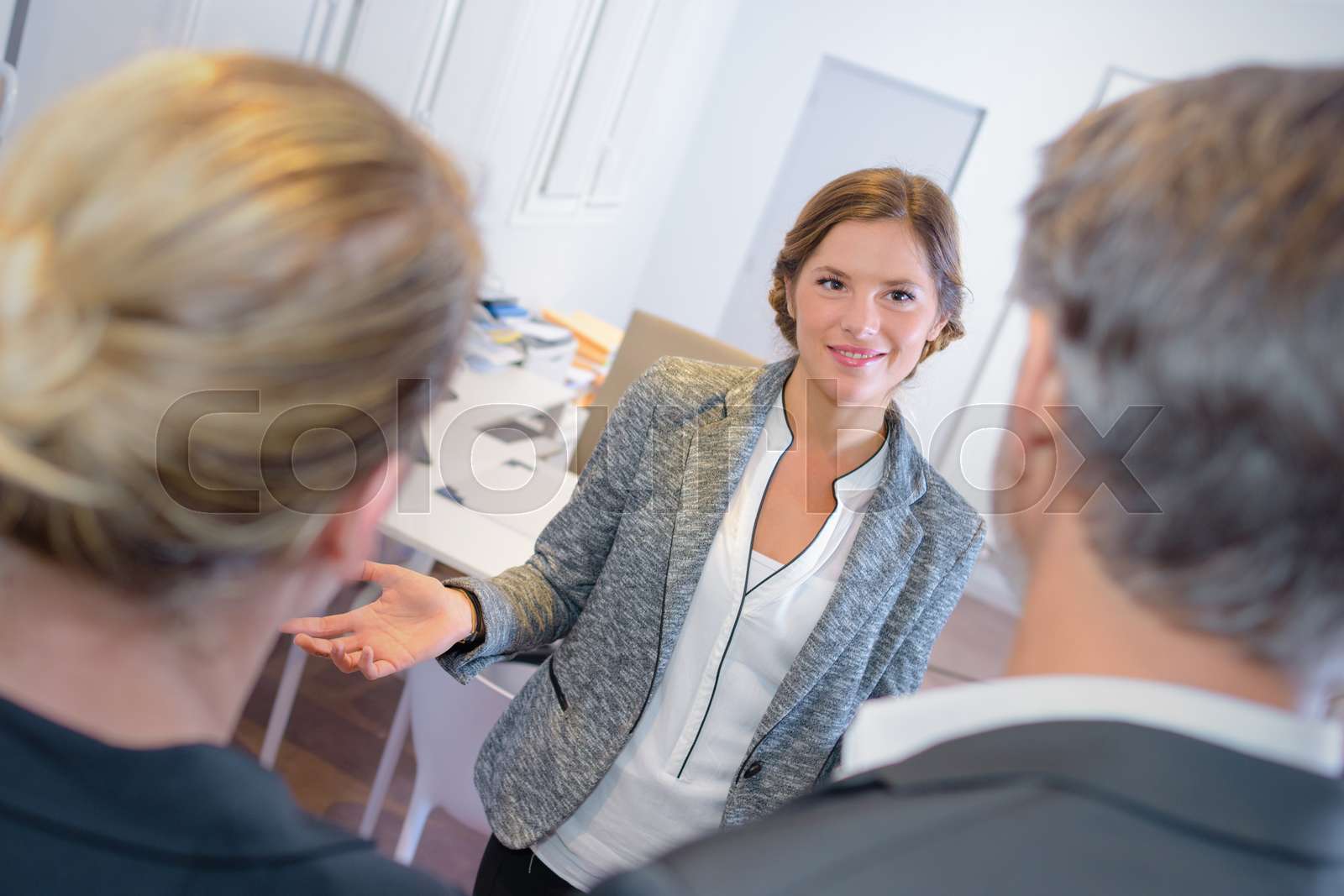 Lady greeting clients | Stock image | Colourbox