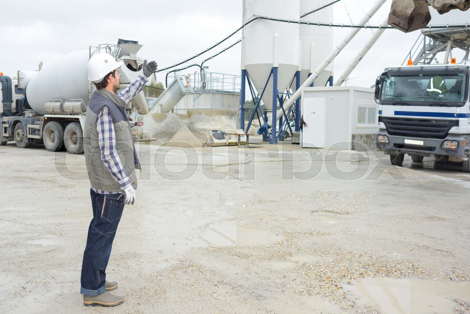 worker directing lorry in silo | Stock image | Colourbox