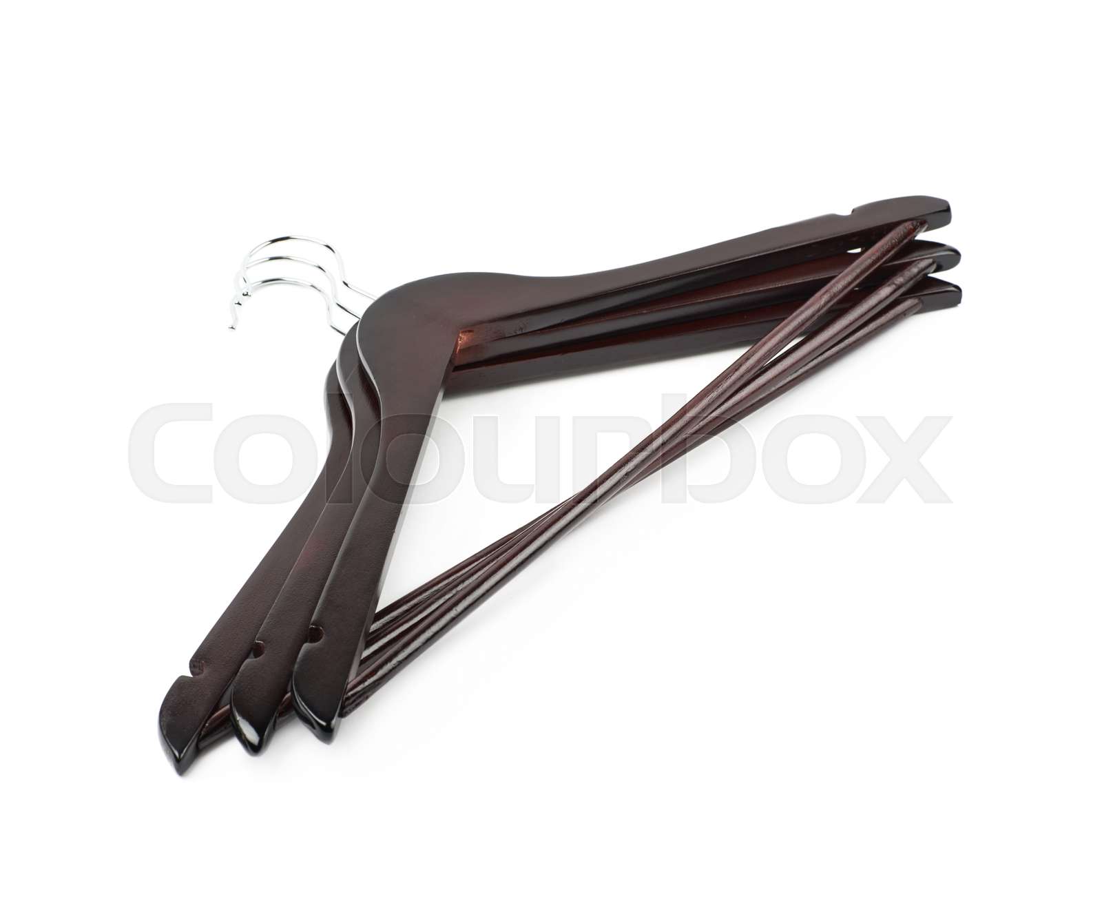 Pile of dark wooden hangers | Stock image | Colourbox