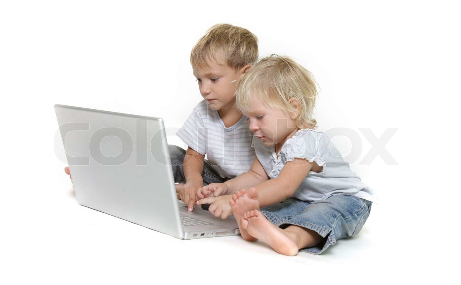 two kids with laptop over white | Stock image | Colourbox