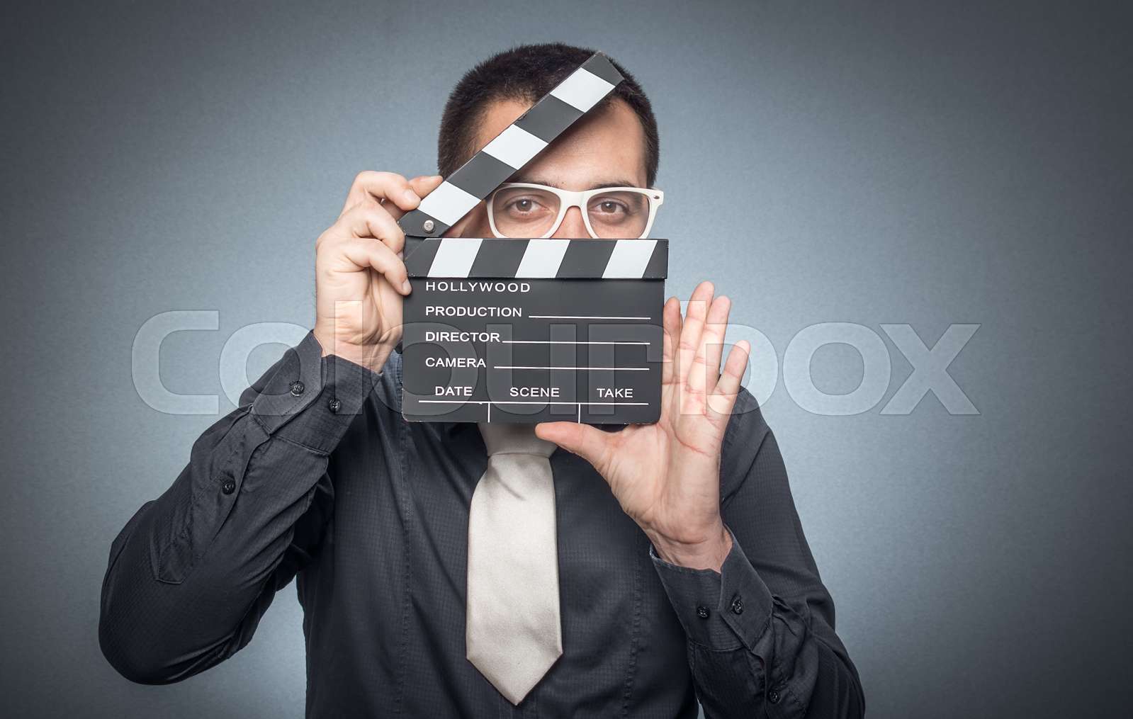 Man with movir clapper board | Stock image | Colourbox