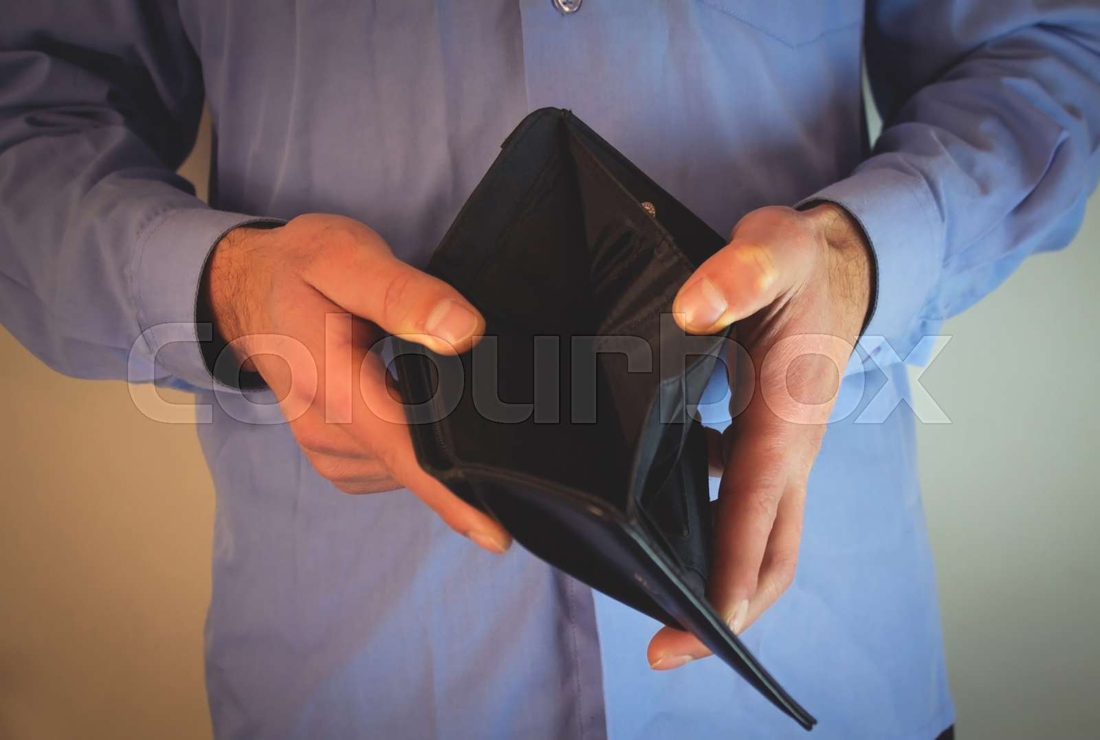 Man holding empty wallet. | Stock image | Colourbox
