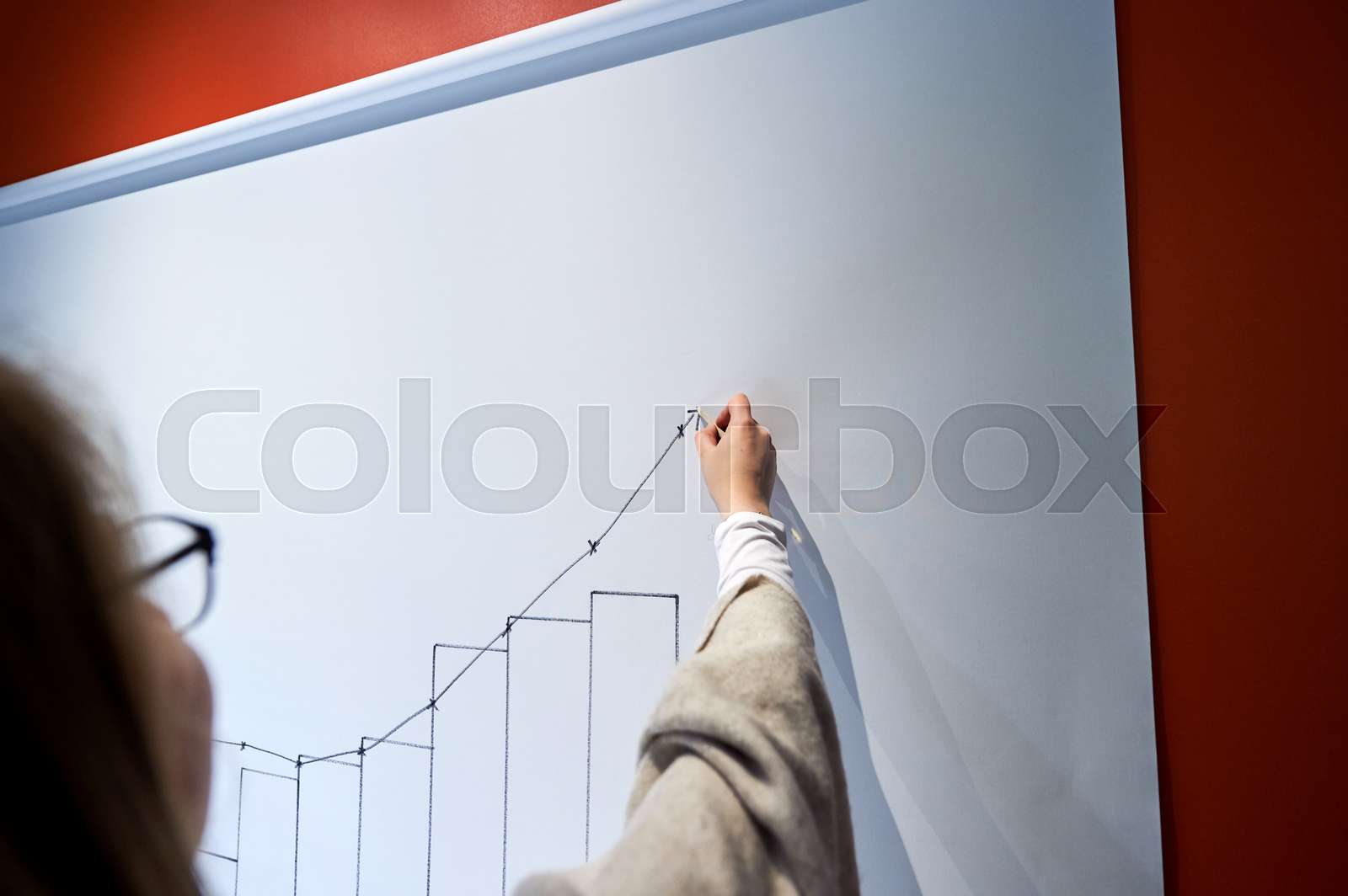 Succes graph drawing on flipchart by woman wearing eyeglasses | Stock ...