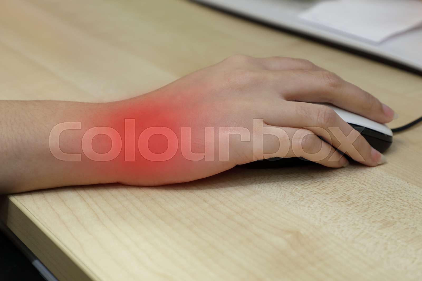 woman using mouse with wrist pain | Stock image | Colourbox