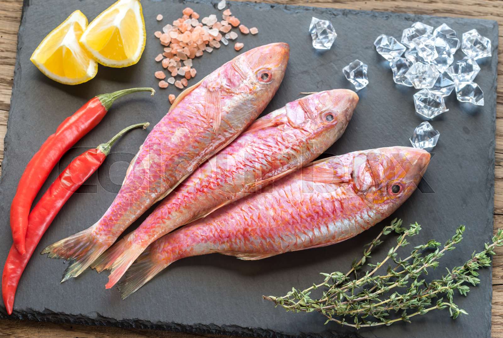 Raw red mullet with ingredients | Stock image | Colourbox