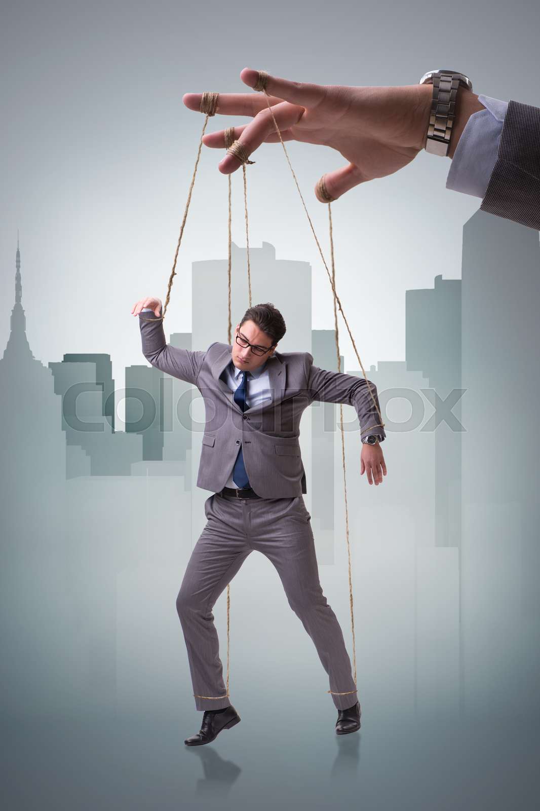 Businessman puppet being manipulated by boss | Stock image | Colourbox