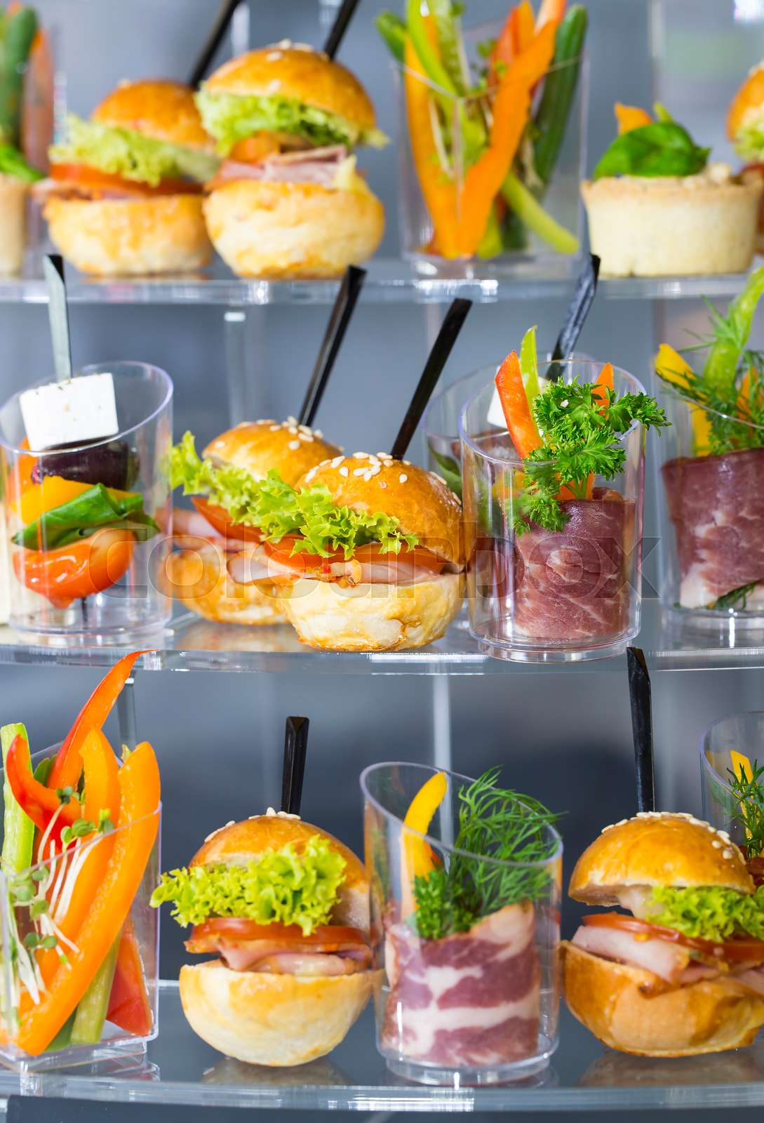 Mini desserts and meat canapes vegetable snacks in plastic cups canapes ...