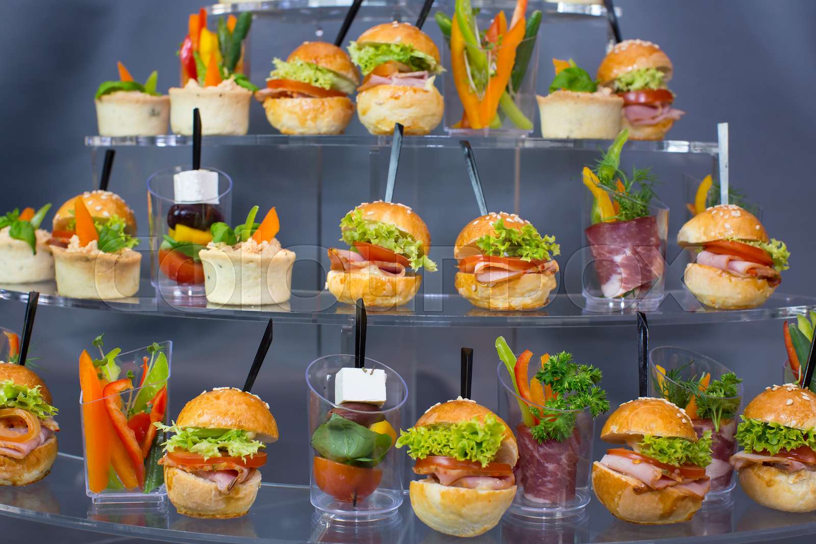 Mini desserts and meat canapes vegetable snacks in plastic cups canapes ...