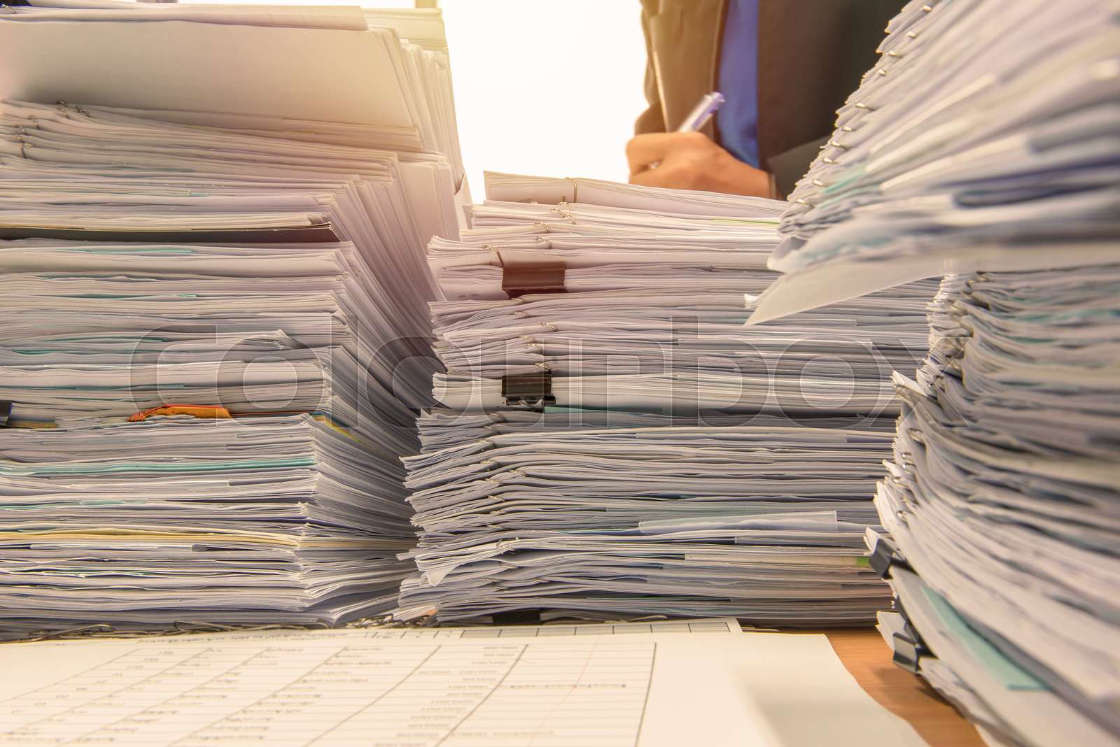 documents on desk stack up high waiting to be managed | Stock image ...