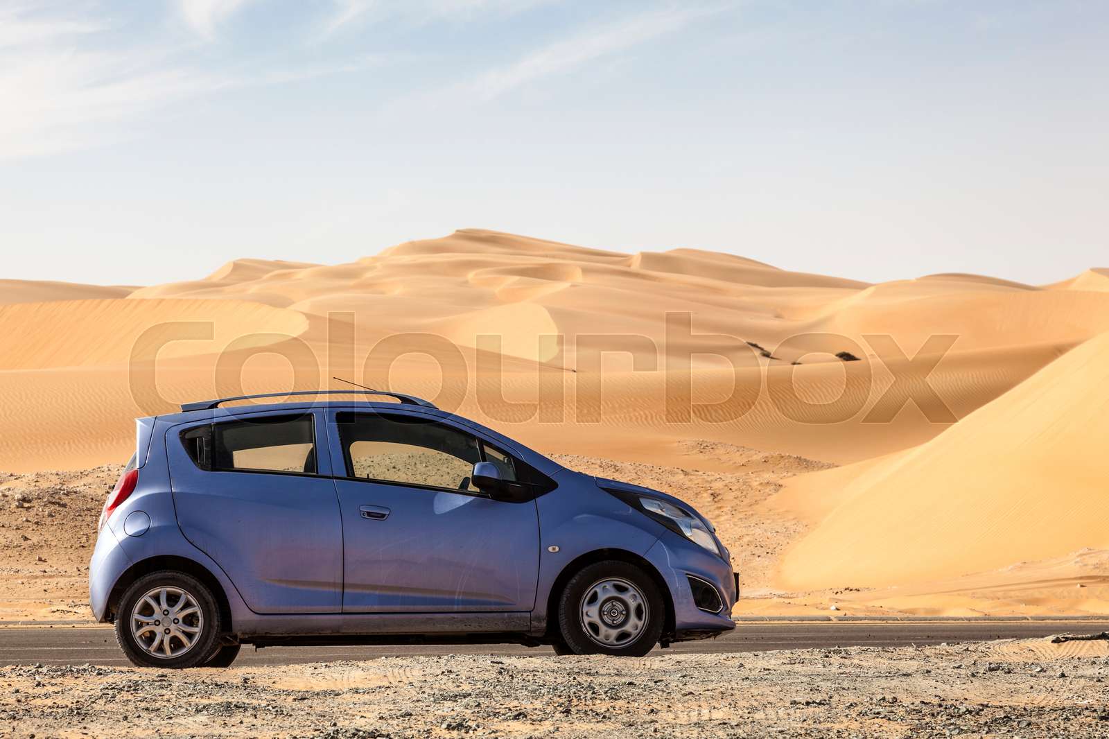 Car at the desert road | Stock image | Colourbox