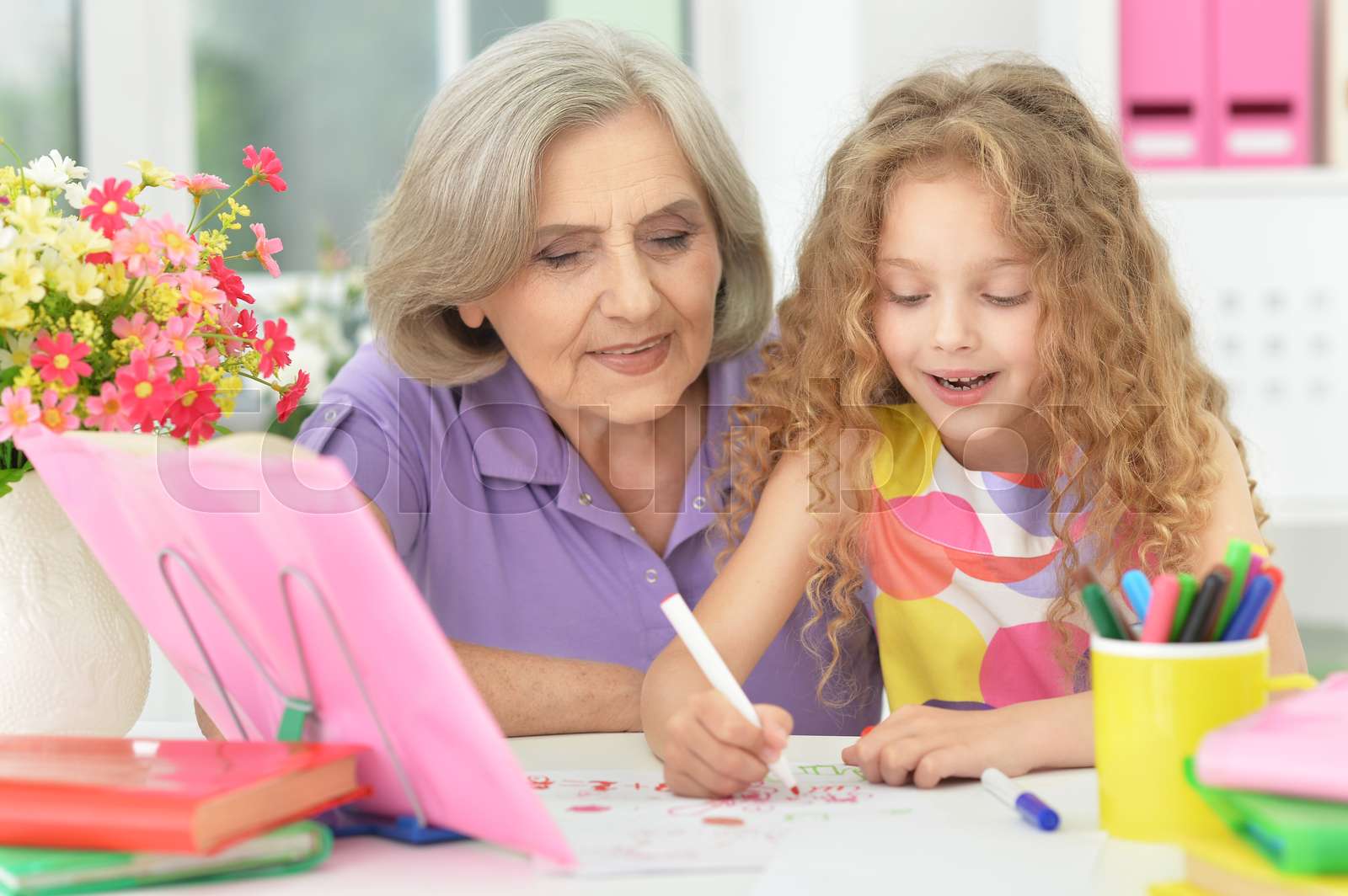 grandmother and granddaughter doing homework | Stock image | Colourbox