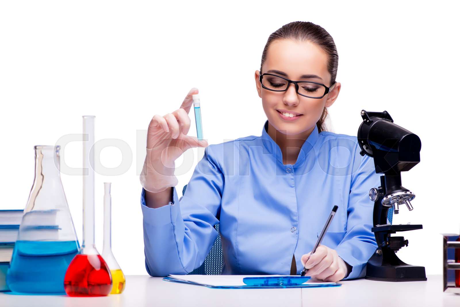 Lab chemist working with microscope and tubes | Stock image | Colourbox