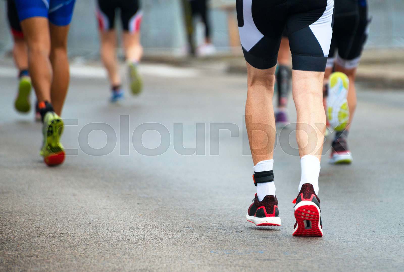 Group of marathon runners on the street. Back view. | Stock image ...