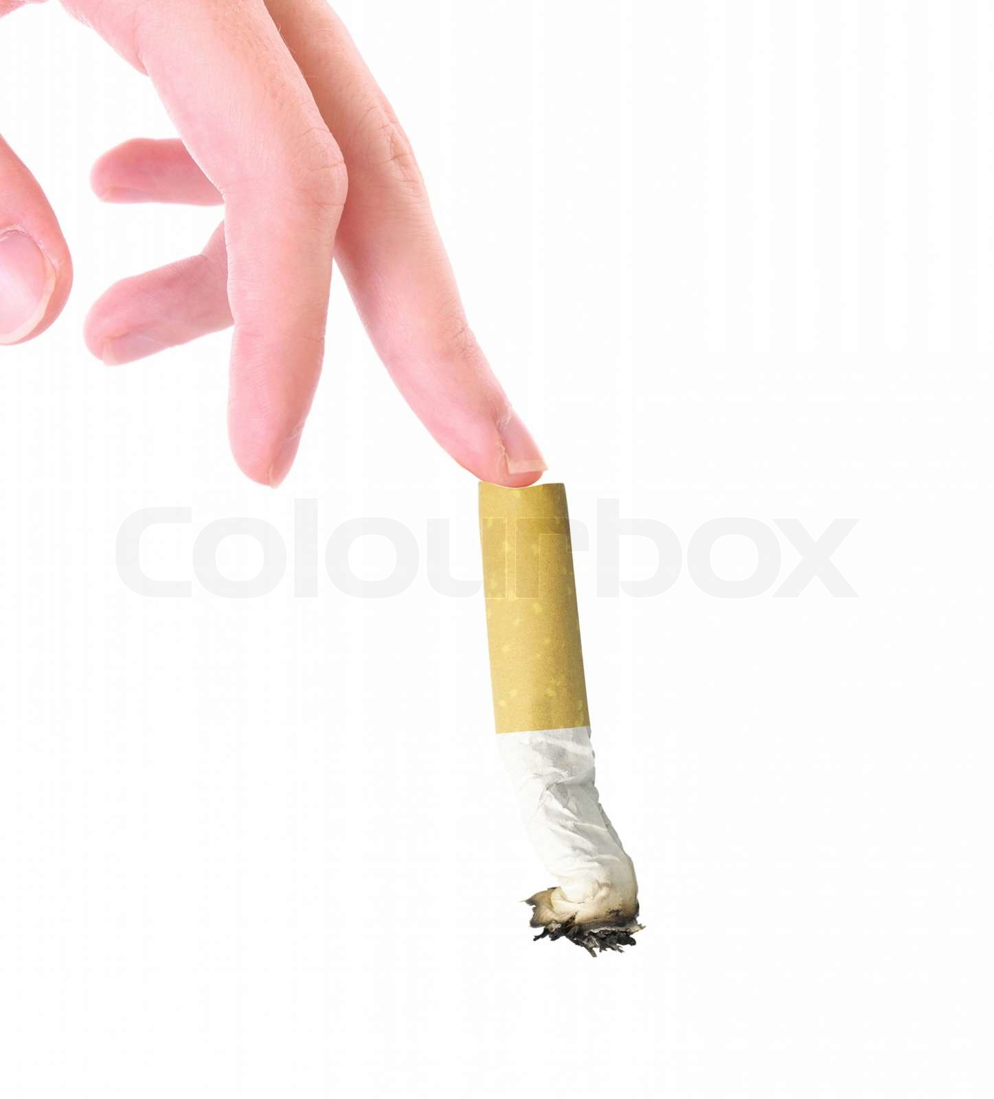 Cigarette in a hand on the white | Stock image | Colourbox