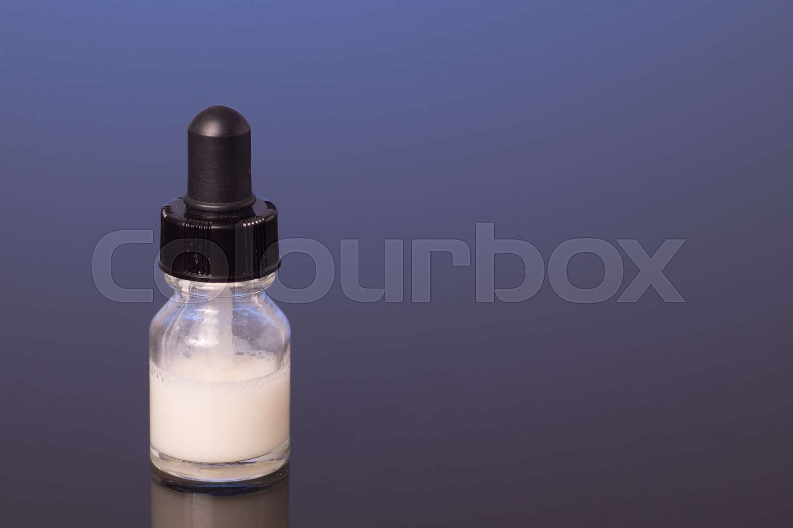 dropper bottle with milk white liquid | Stock image | Colourbox