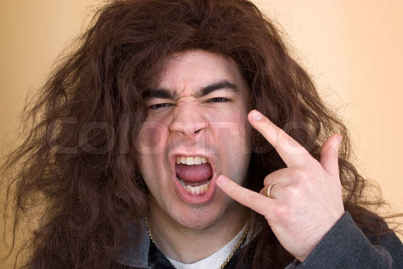 A rocker dude goes wild and starts head banging | Stock image | Colourbox