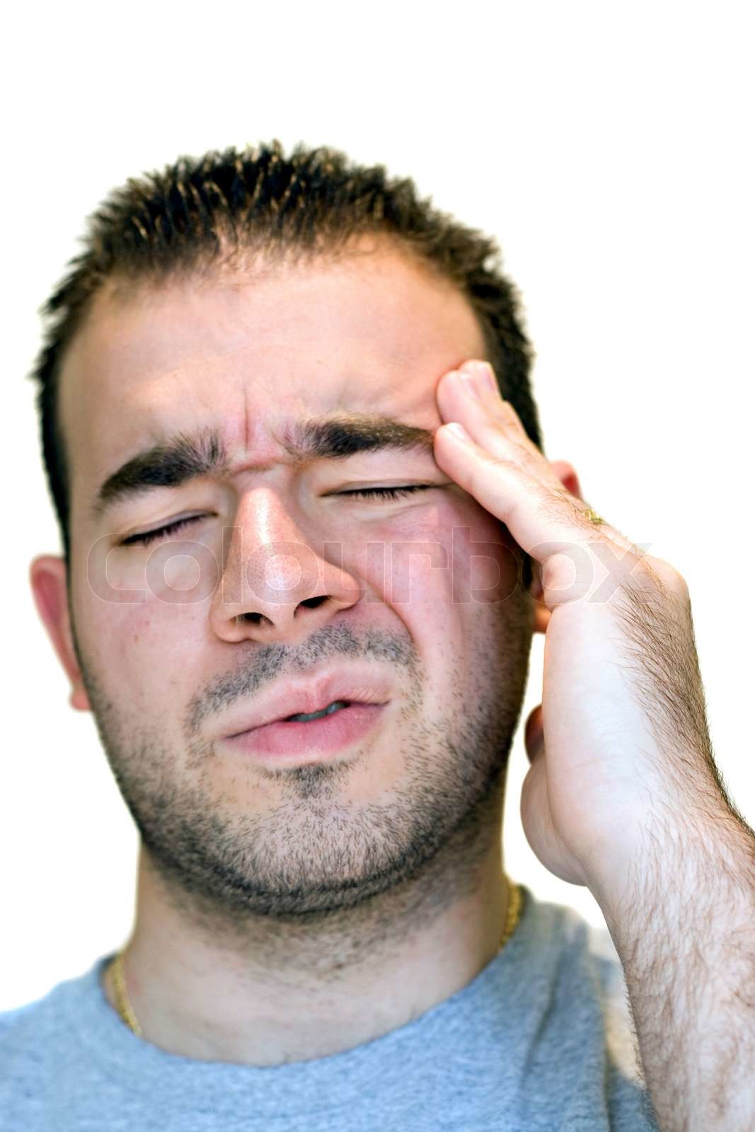 A young man grasps his head in anguish from pain or even stress | Stock ...