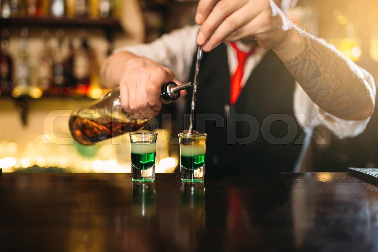 Barman making attractive alcoholic cocktail | Stock image | Colourbox