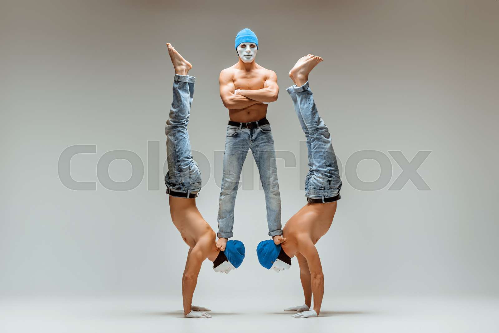 The group of gymnastic acrobatic caucasian men on balance pose | Stock ...